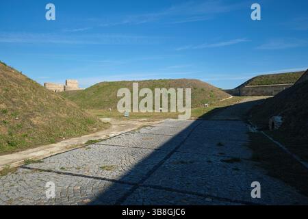Exterior view of the berm design and fortifications of the complex. At ...