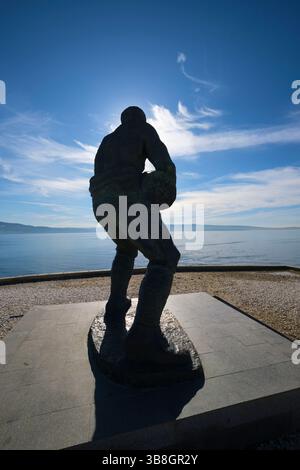 A silhouette view of the hero carrying an artillery shell. At the ...