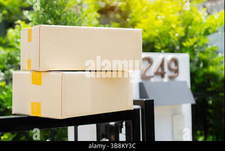 Stack of parcels delivered near front gates Stock Photo - Alamy