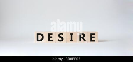 Desire symbol. Concept word Desire on wooden cubes. Beautiful yellow ...