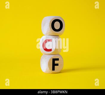 OCF - Operating Cash Flow. Wooden blocks on a white office table Stock ...