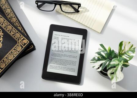 E-book reader device in home library, top view Stock Photo - Alamy