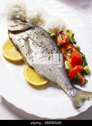 Just baked freshwater bream fish cooked with fresh rosemary and species ...