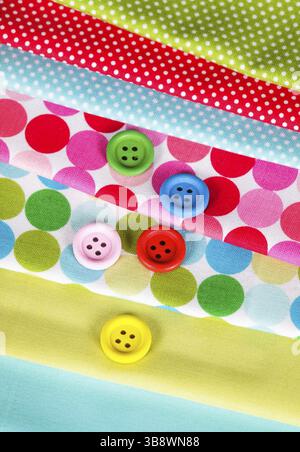 Colorful wooden buttons on the textiles, sew concept Stock Photo - Alamy