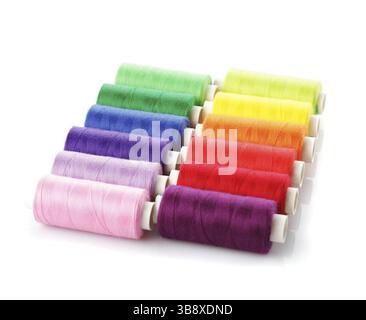 Many sewing threads on color background Stock Photo - Alamy