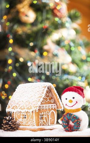 Gingerbread house over on the snow and lovely handmade snowman Stock ...