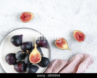 Exotic fruits, purple fig. Flat lay, direct sunlight with shadows ...