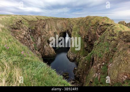The rugged coast of Bullers of Buchan is located south of Peterhead in ...