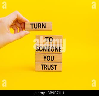 Turn to Someone you trust symbol. Wooden blocks with words Turn to ...