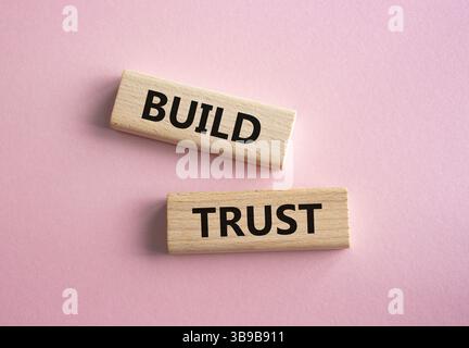 Build trust symbol. Wooden blocks with words Build trust. Beautiful ...