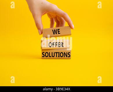 We offer solutions symbol. Concept words We offer solutions on wooden ...