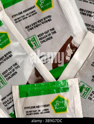 Packs of ethylene absorbent used in food packaging, labeled with a ...