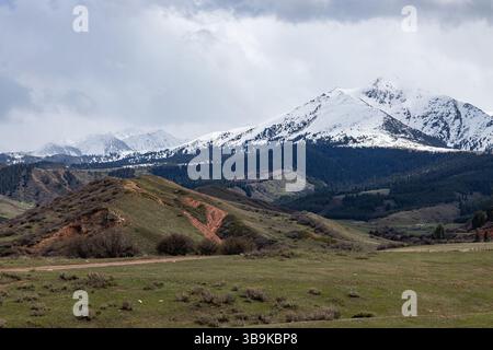 Majestic Snow-Capped triangular mountain and Countryside Road. Natural ...