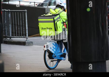 Sydney, Australia. 10th May 2025. An Uber Eats delivery rider rides on ...