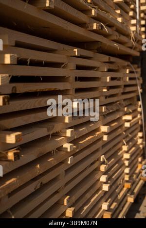 Wooden planks stacked neatly in a workshop showcasing the materials ...