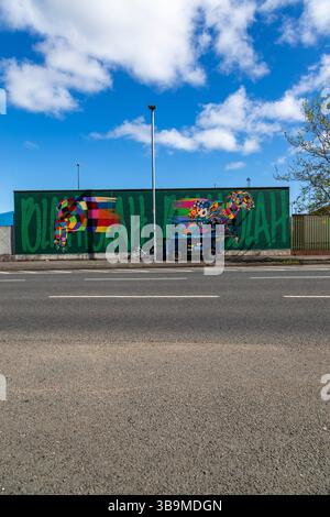 Artist Louis Masai working on a mural for Hit the North Translink ...