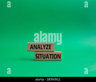 Analyze situation symbol. Wooden blocks with words Analyze situation ...