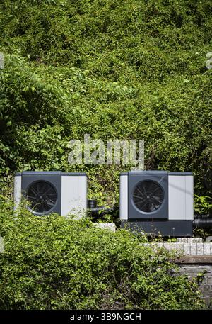 Two air source heat pumps installed outside of a modern house Stock ...