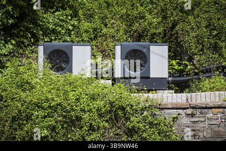 Two heat pumps are elevated on a wall in Wuppertal, Germany, Europe ...