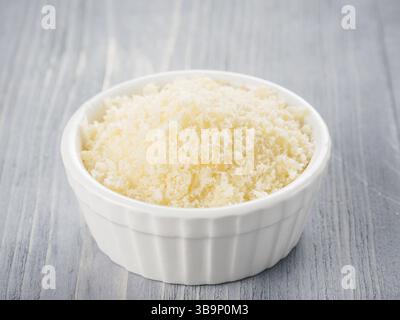 Shredded parmesan on gray wooden table Stock Photo - Alamy