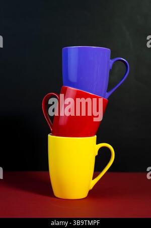 Black and red ceramic cups on white background Stock Photo - Alamy