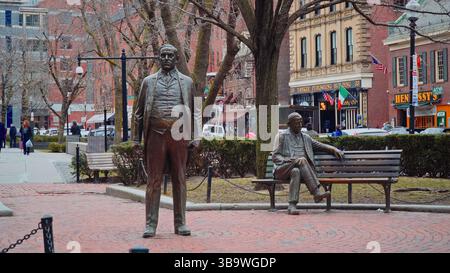 A Statue in James Michael Curley Park wears a traffic cone as people ...