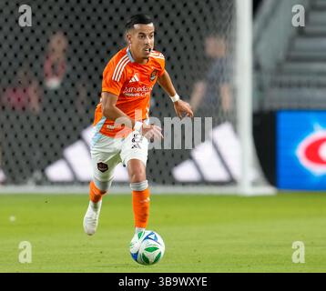 Houston Dynamo midfielder Amine Bassi, right, is tripped up by CF ...