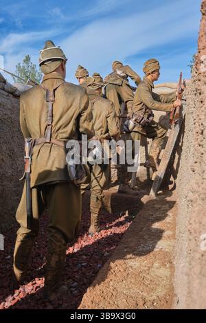 Turkish troops, lined up in formation, preparing to climb a ladder over the trench wall. At The ...