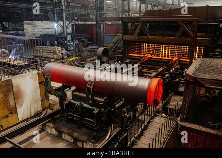 Freshly cast red hot iron pipe at the foundry Stock Photo - Alamy