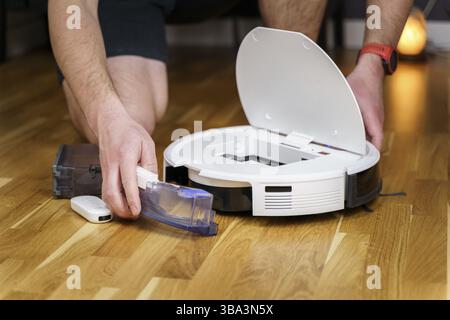 Robotic vacuum cleaner hoovering the floor at christmas Stock Photo - Alamy