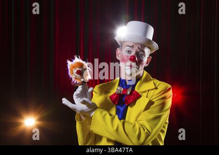 Circus clown performs number. A man in a clown outfit with a toy Stock ...