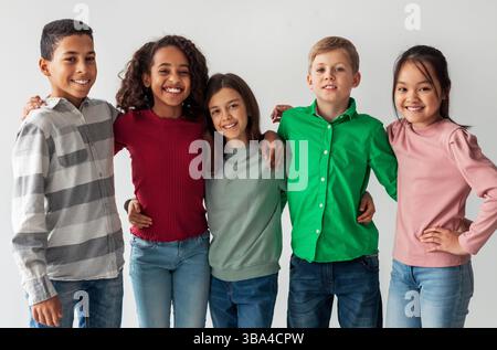 Multiracial Preteen Children Posing Together Against a Simple White ...