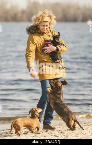 A person takes their dog for a walk on a trail overlooking Lake Ontario ...