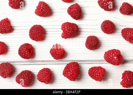 Tabletop view, raspberries spilled on white boards Stock Photo - Alamy