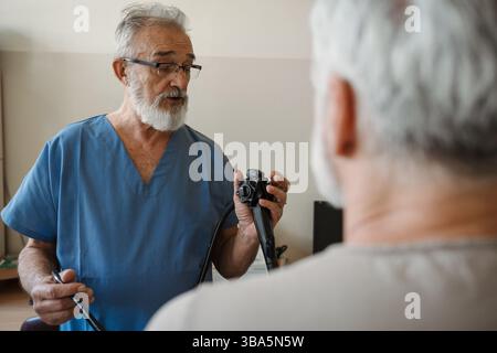 Doctor explaining gastroscopy procedure on patient. Examination of ...