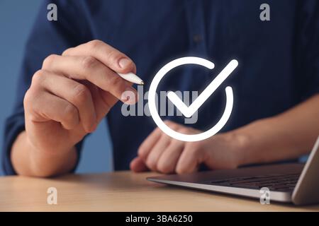 Approved. Man using laptop and touching virtual screen with check marks ...