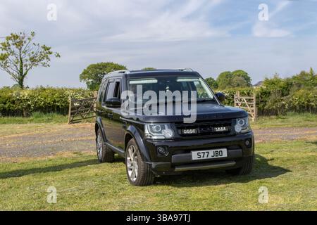 Modified black Land Rover Discovery Series I 4x4 climbing a dusty hill ...