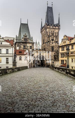 Autumn dawn in historic Prague at Charles Bridge over the Vltava River. Prague, ENESCO monument ...