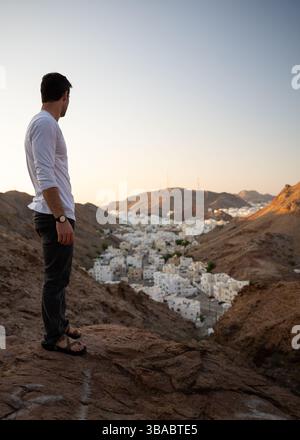 A man stands at the Yiti Round Point of View in Oman, gazing out at the ...