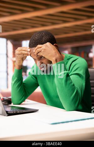 African American man at home clueless and confused expression with arms ...