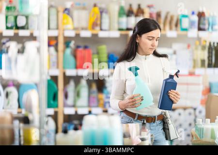 customer chooses between two sprays while standing in a supermarket ...