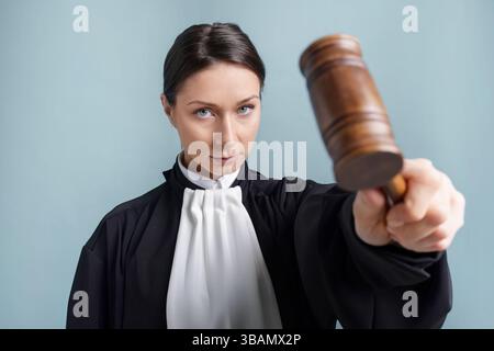 Judge with mallet on light blue background Stock Photo - Alamy