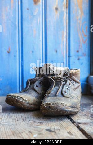 Old shoes on brown wood background Stock Photo - Alamy