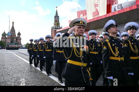Two naval officers render a salute during a change-of-command ceremony ...