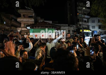Idlib City, Syria. 13th May, 2025. Syrians set off fireworks during ...