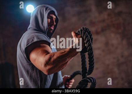 Strong man bodybuilder holds the rope Stock Photo - Alamy
