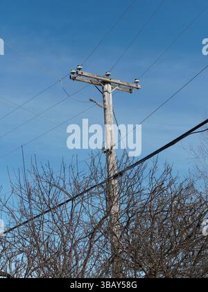 Landline telephone cable and wooden post against blue sky Stock Photo ...
