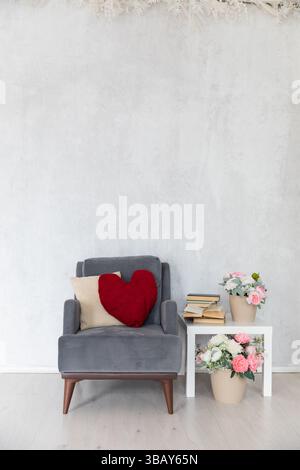 Armchair with cushions, side table, books and decor isolated on white ...
