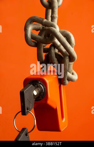 double disc lock on orange background Stock Photo - Alamy