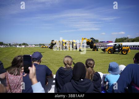 People watching 'JCB Dancing Diggers' during the first day of the ...